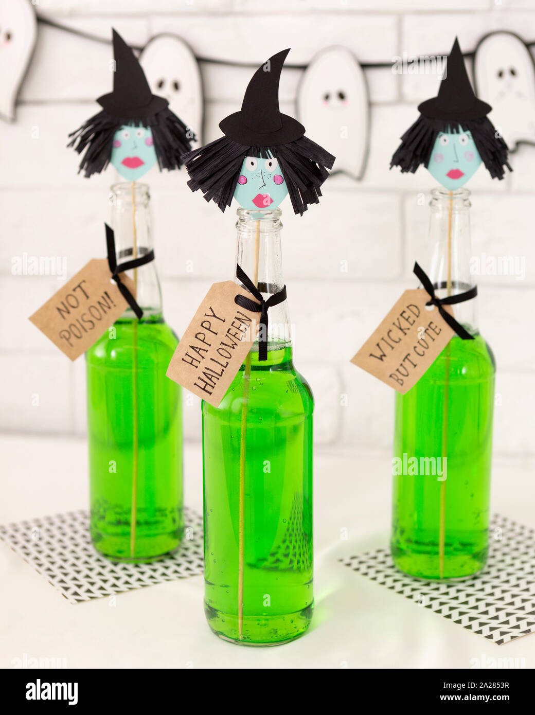 Green toxic cocktail with paper heads on white Stock Photo - Alamy