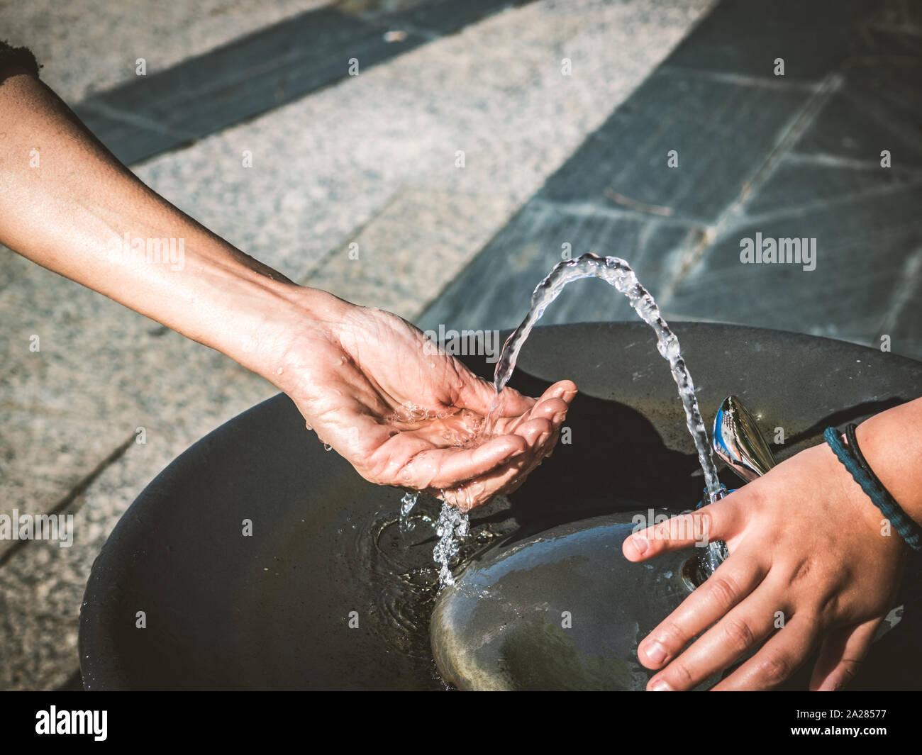 Girl hands in water fountain hi-res stock photography and images - Alamy