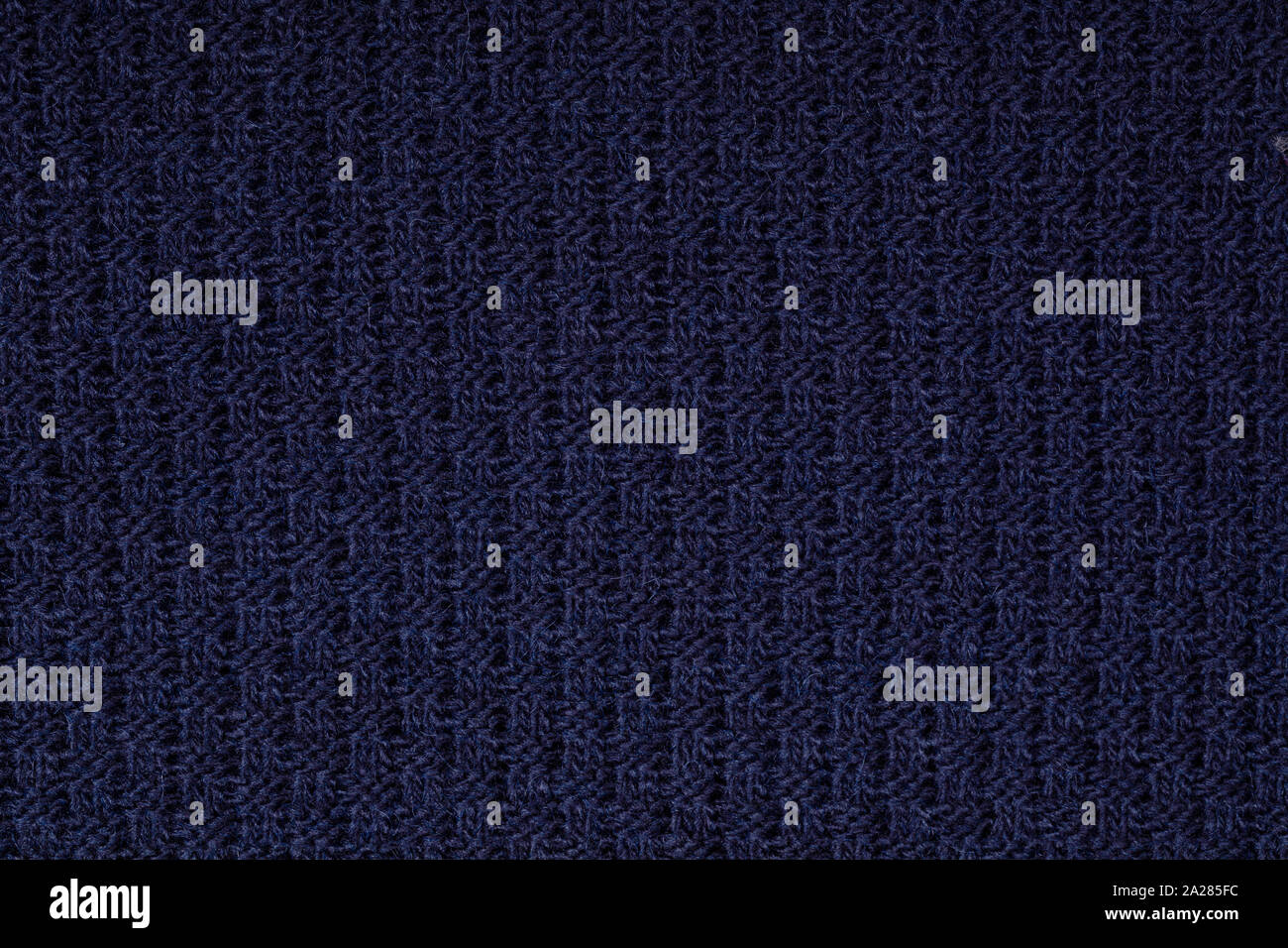 Real deep blue knitted fabric with ornamental pattern textured ...