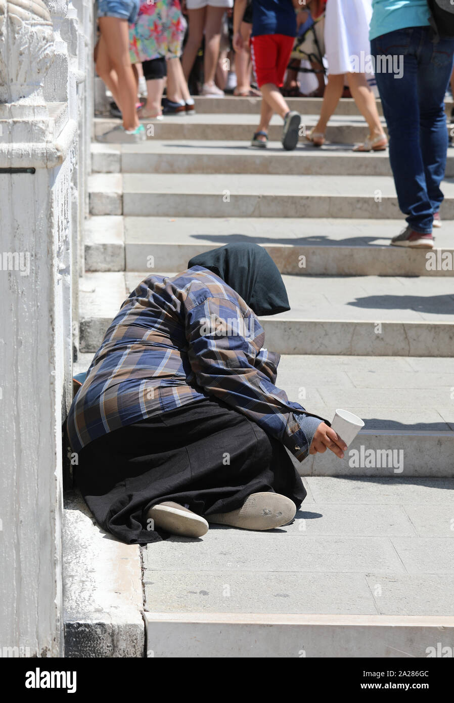 old woman squatting on the street begging people Stock Photo - Alamy