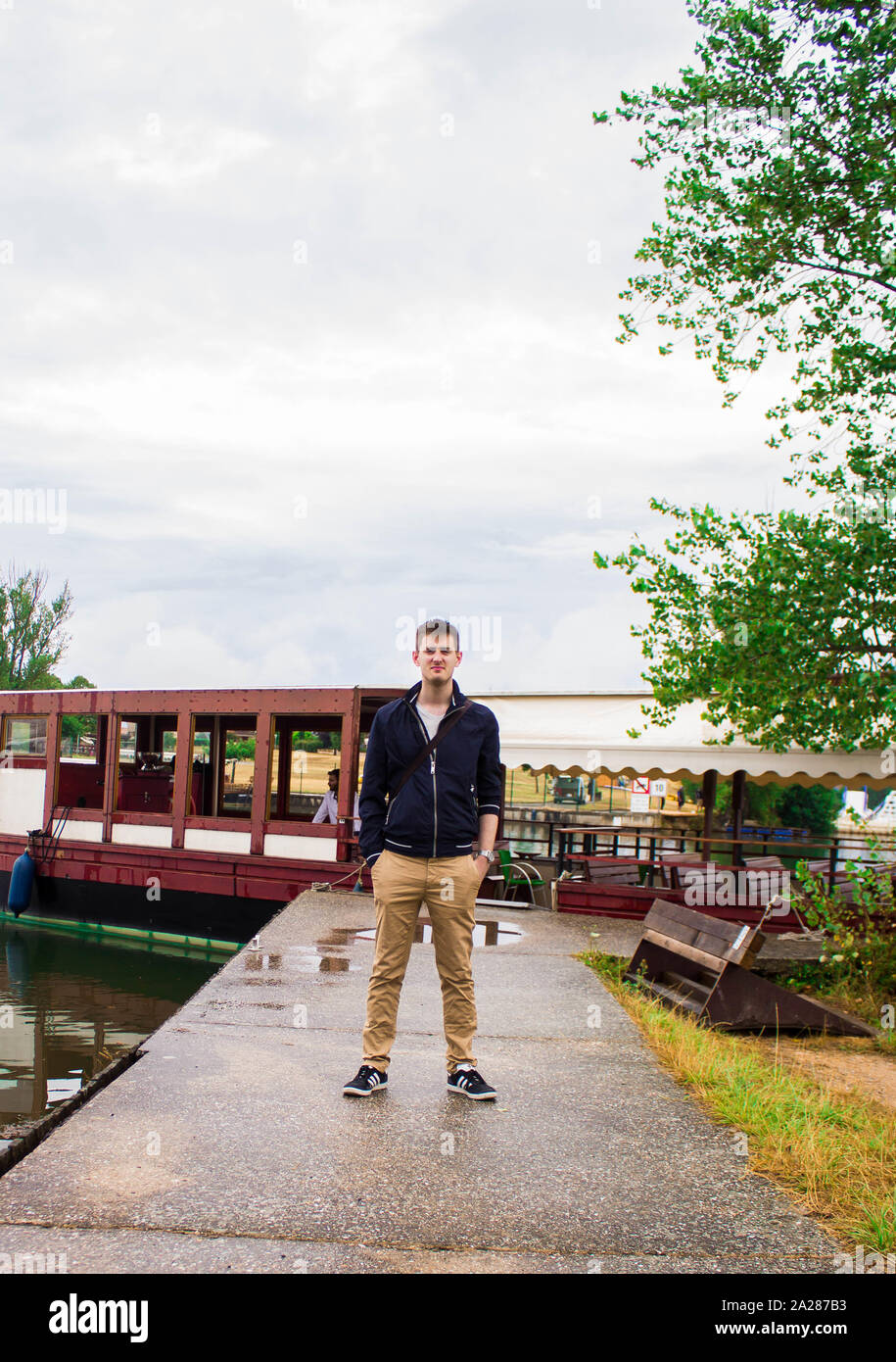 young boy on a catwalk to get on the boat Stock Photo - Alamy