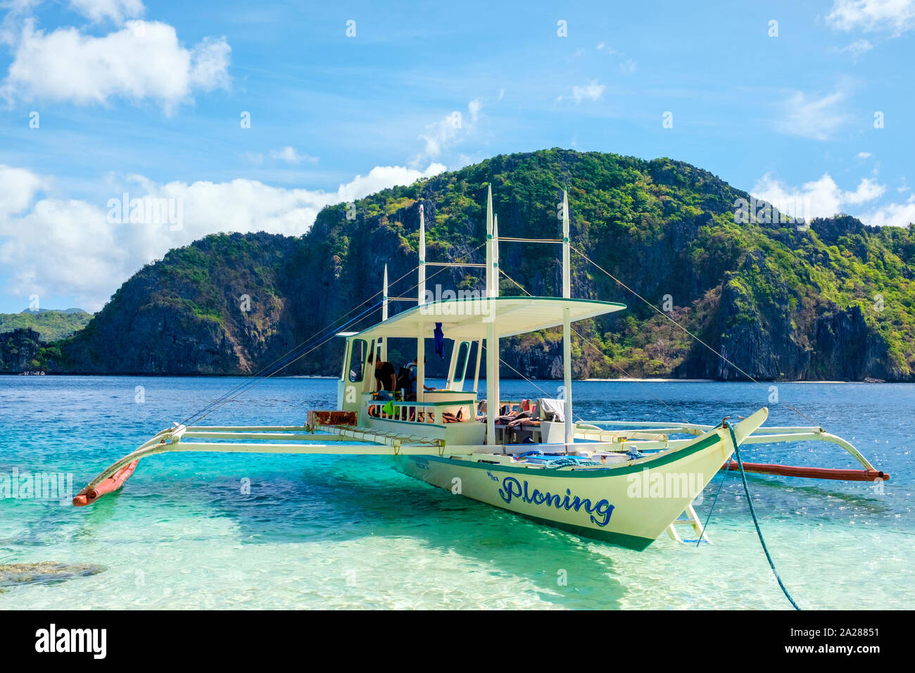 Outrigger boat anchored at Talisay Beach, Tapiutan Island, El Nido ...