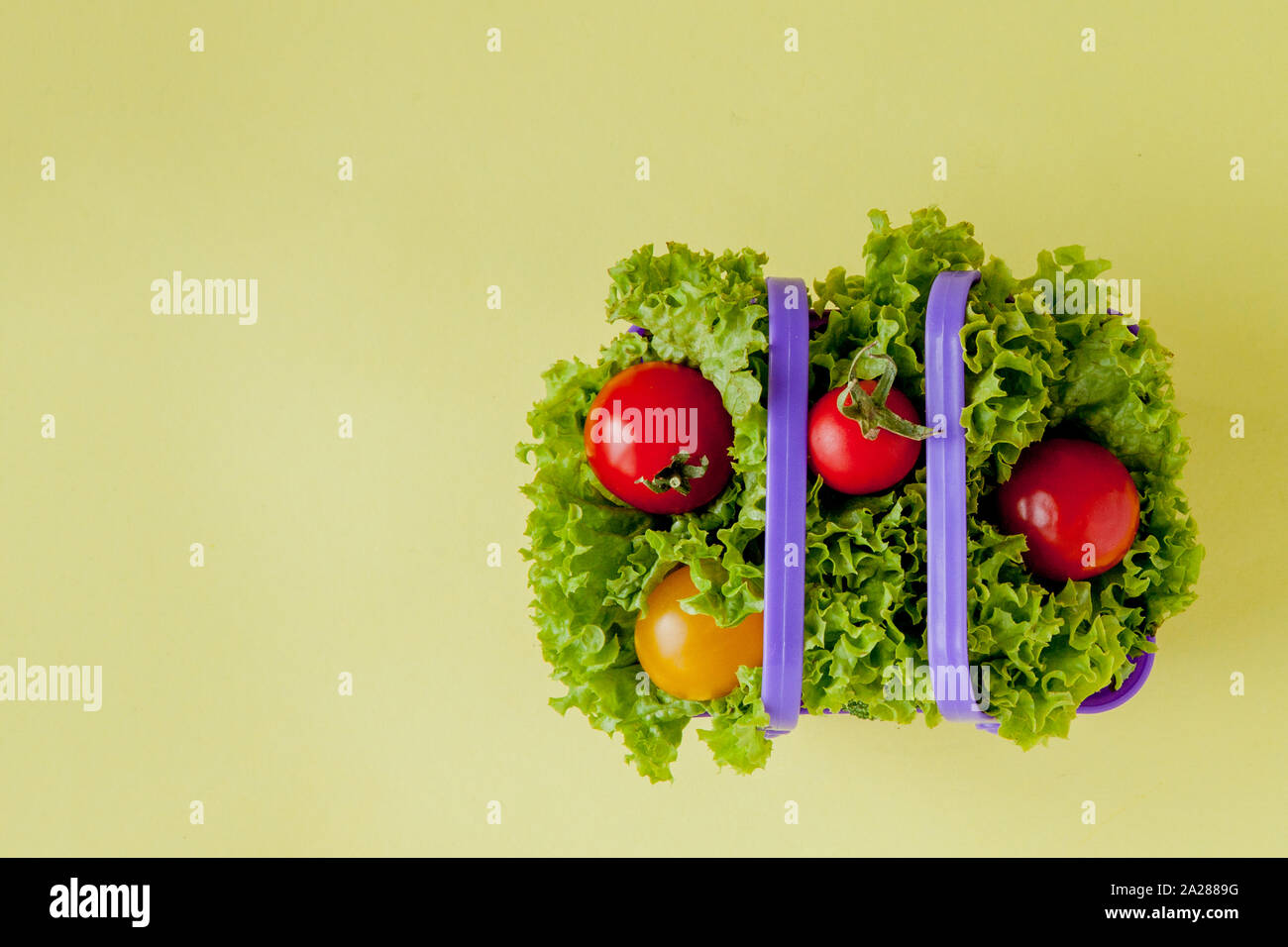 Small Fresh vegetables in basket on yellow background. Food background ...