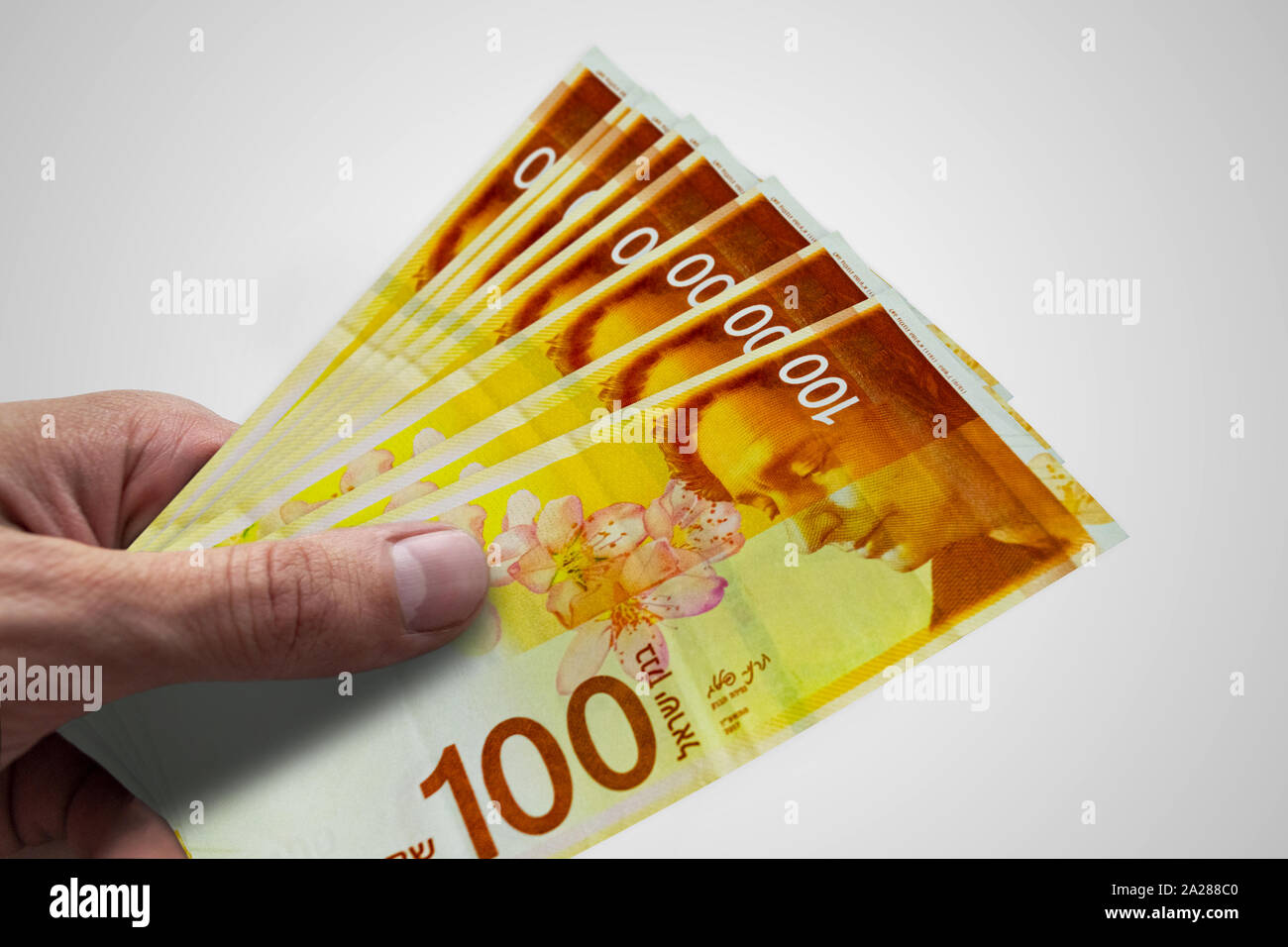 Hand holding Israeli shekels. ILS. Money of Israel Stock Photo - Alamy