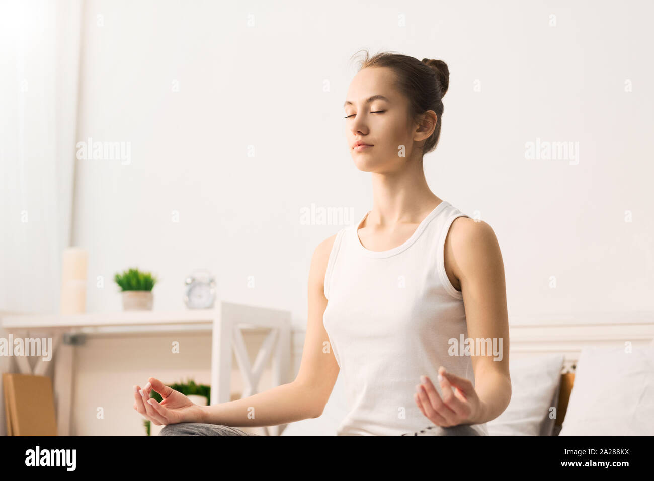 Fit girl doing lotus pose hi-res stock photography and images - Alamy