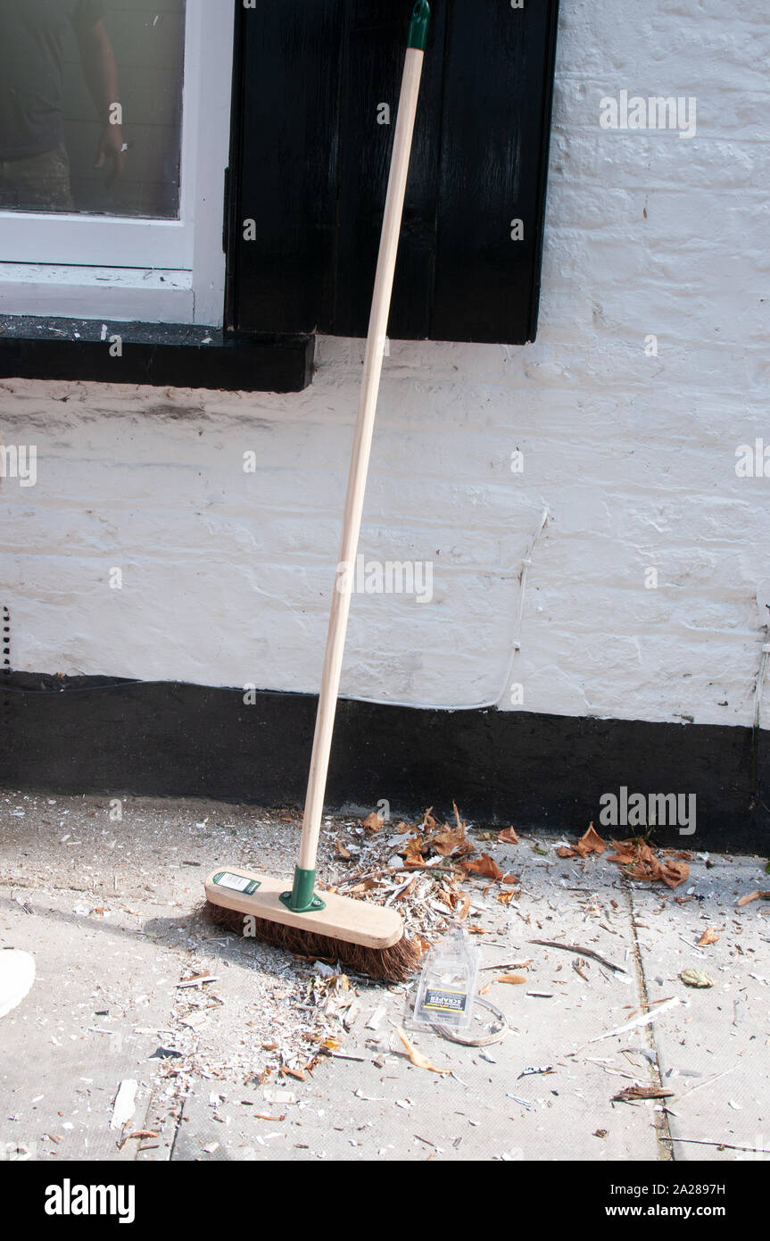 broom leaning against exterior of a house Stock Photo - Alamy