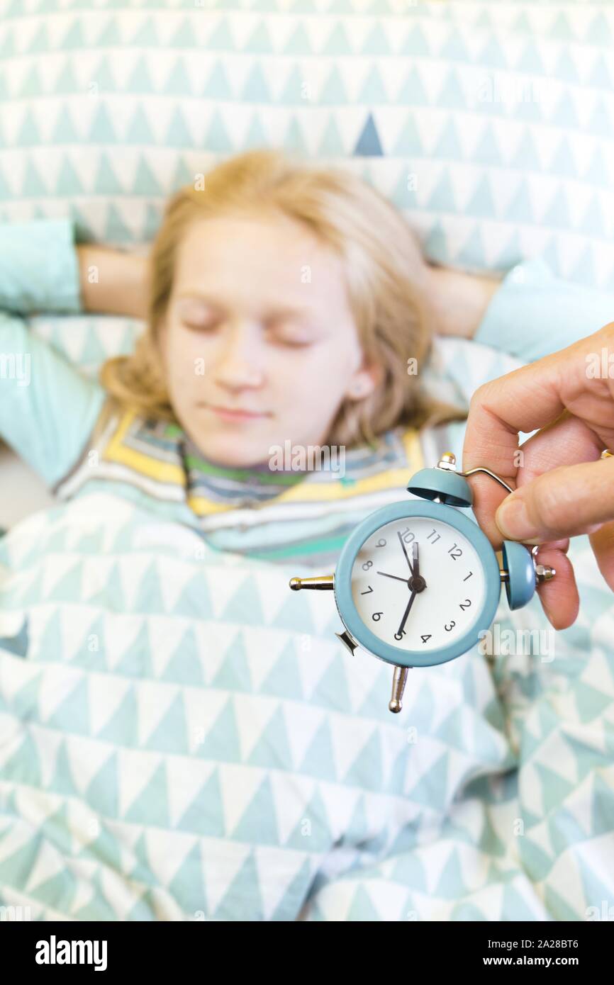 alarm clock disturbing a sleeping little girl that is defocused Stock ...