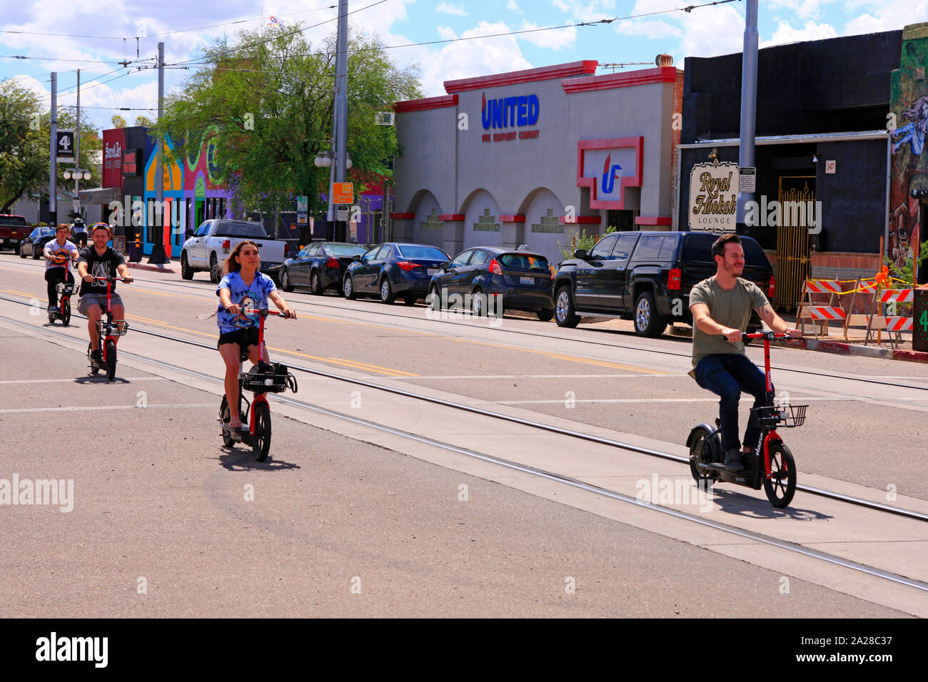 Young people riding the new Razor electric scooter along 4th Ave in ...