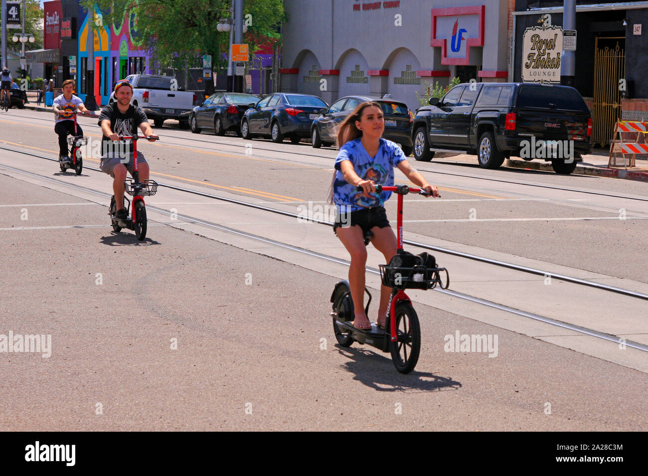 Young people riding the new Razor electric scooter along 4th Ave in ...