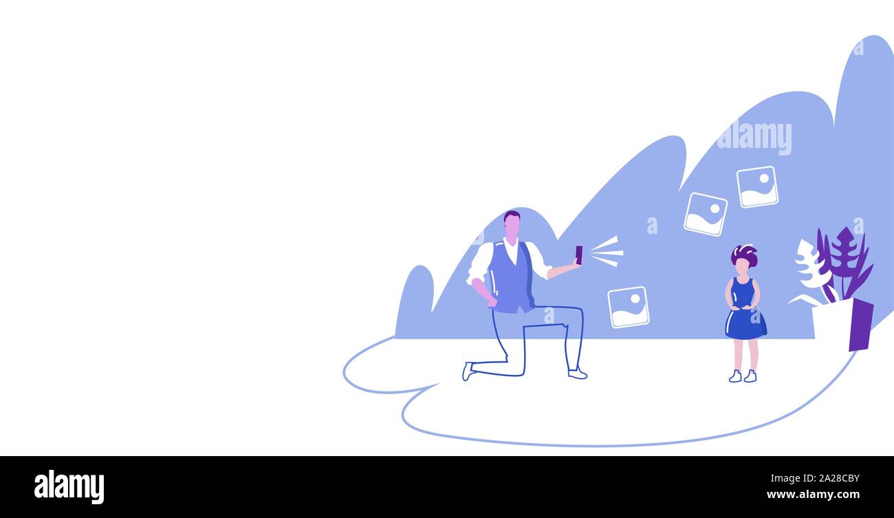 man using smartphone camera father standing on knee taking photo of ...