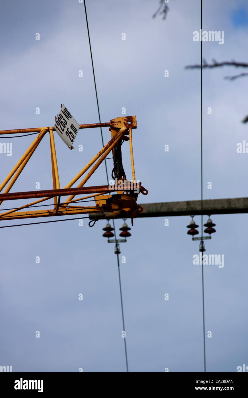 Crane moves at safety distance under a power line Stock Photo - Alamy