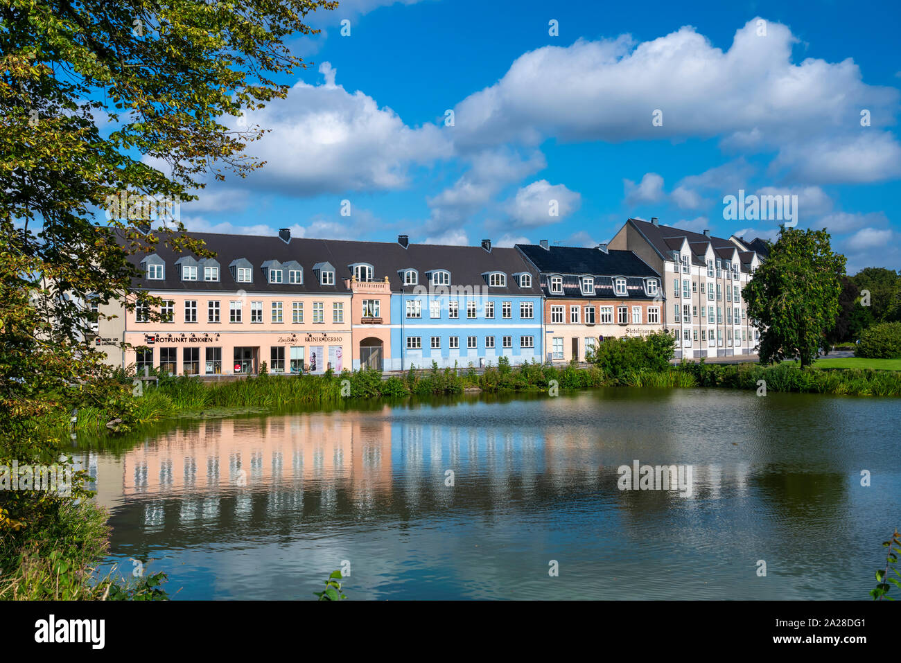 Row housing of Danish architecture reflected in a pond in the village ...