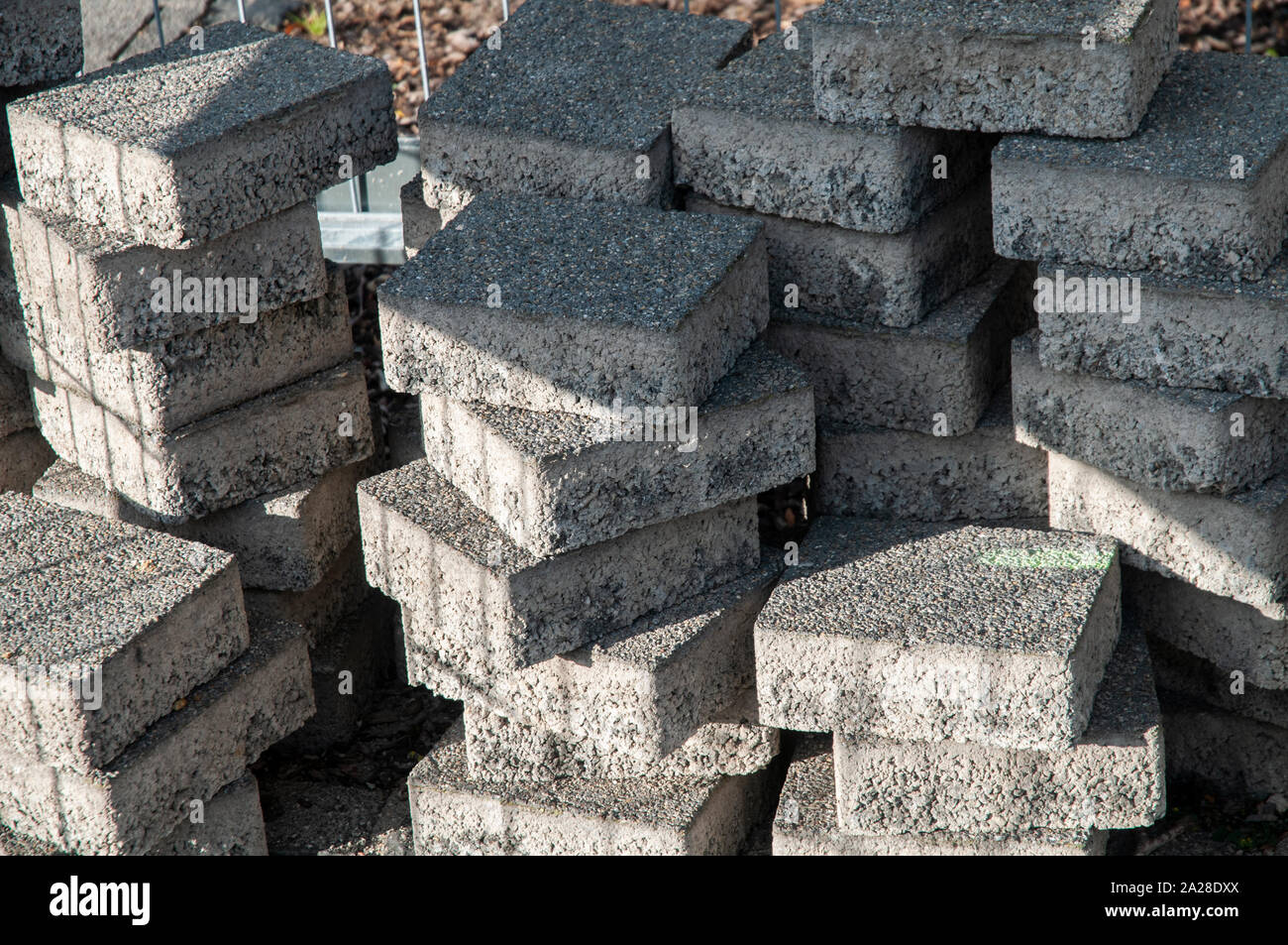 stack of brick shaped gray cement stones for pavement at road ...