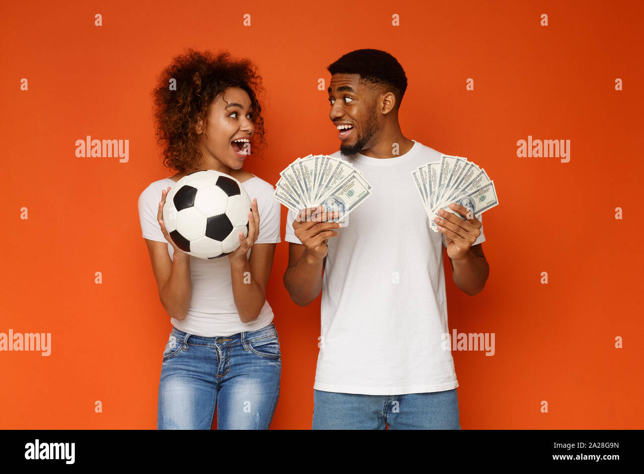 Amazed african american football fans enjoying their win Stock Photo ...