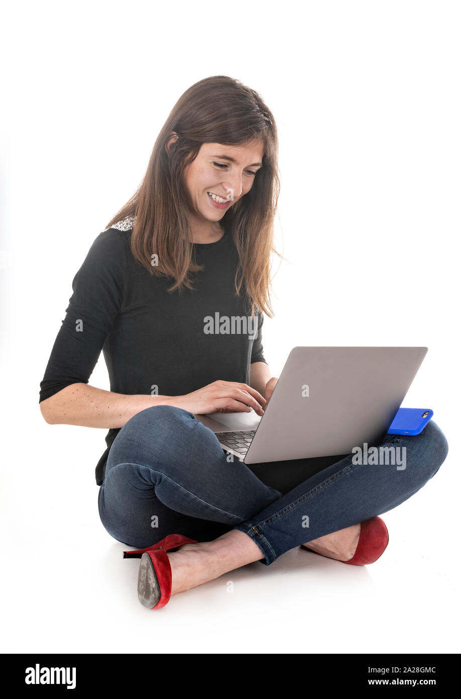 woman and laptop in front of white background Stock Photo - Alamy