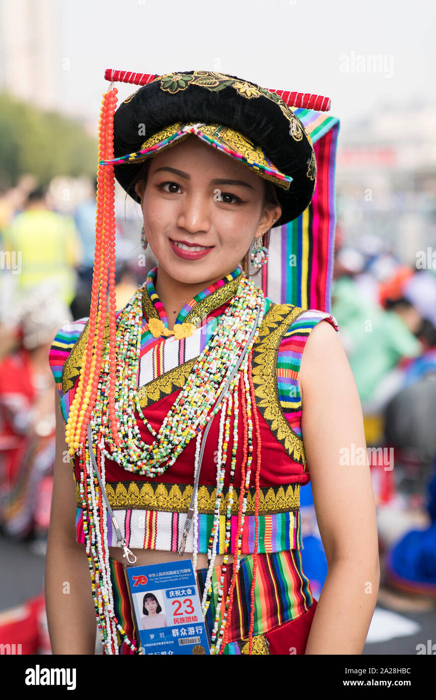 Beijing, China. 1st Oct, 2019. Luo Yue of Nu ethnic group poses for a photo before marching in a ...