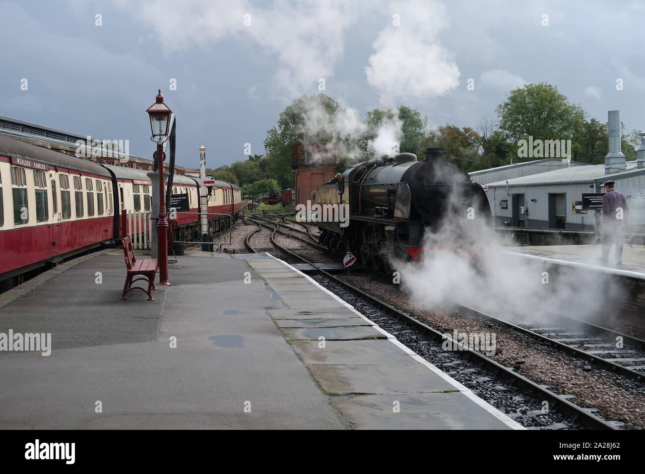 Steam train arriving at a station platform Stock Photo - Alamy