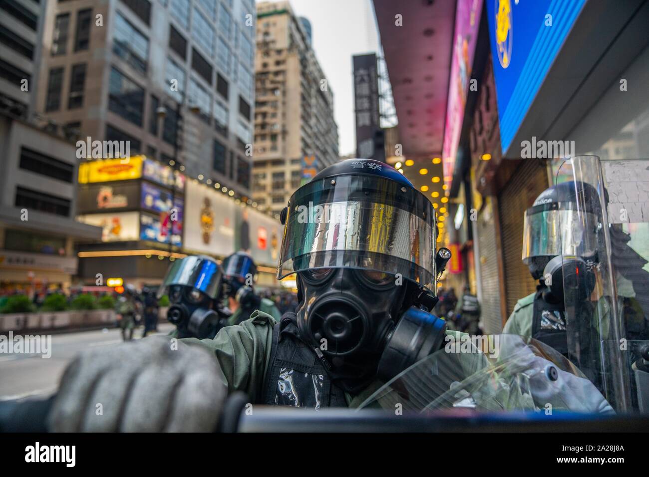 A riot police officer push journalist away using his baton.Entering the ...