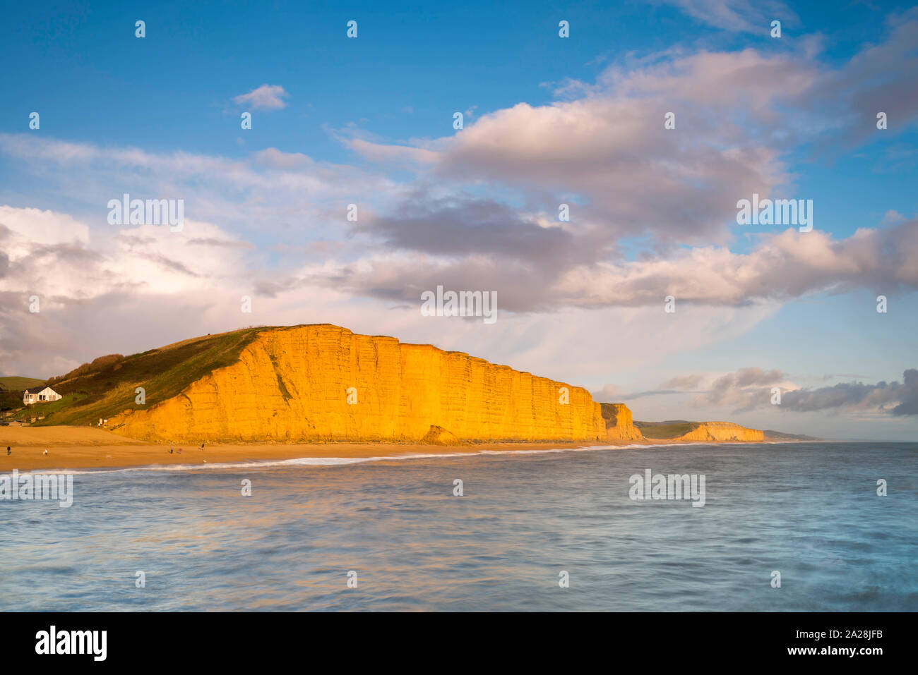 West Bay, Dorset, UK. 1st October 2019. UK Weather. The cliffs at West Bay in Dorset glow a ...