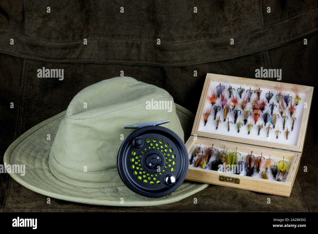 Fly fishing reel and fly box with hat on an outdoor coat Stock Photo ...