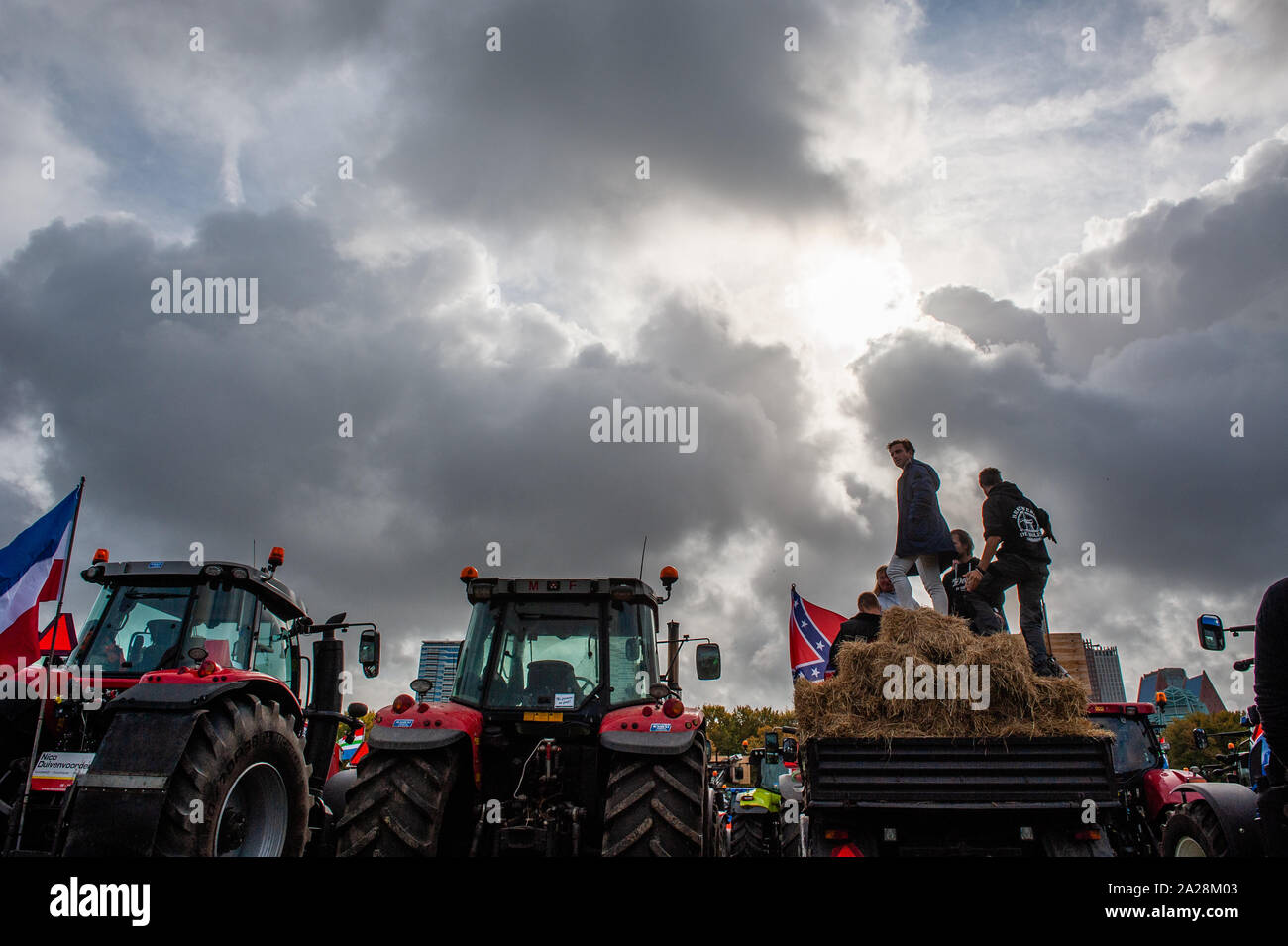 Farmers standing on top of a tractor with a confederate flag during the ...