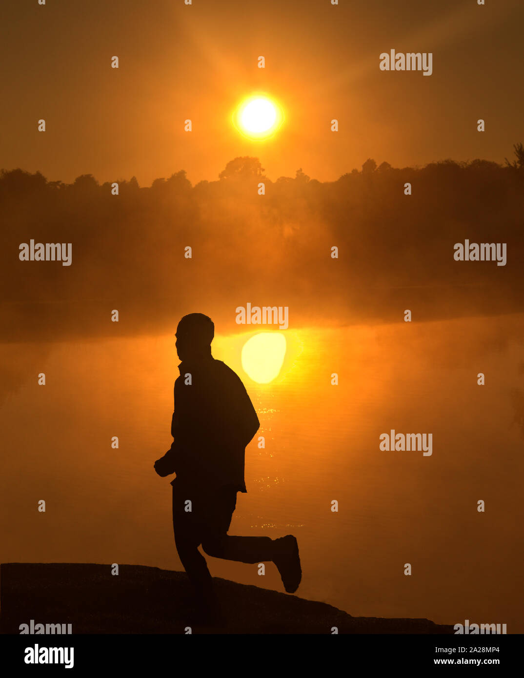 Sunrise on Lake with Runner Stock Photo - Alamy