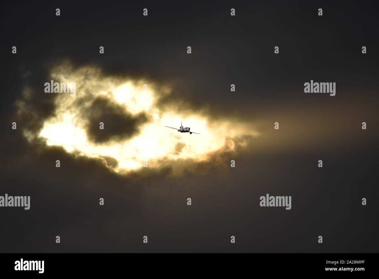 Airplane flying in dark clouds hi-res stock photography and images - Alamy