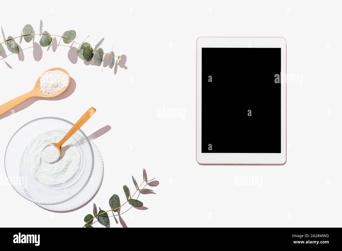 Flat layout of tablet device with empty screen next to organic cosmetic ...