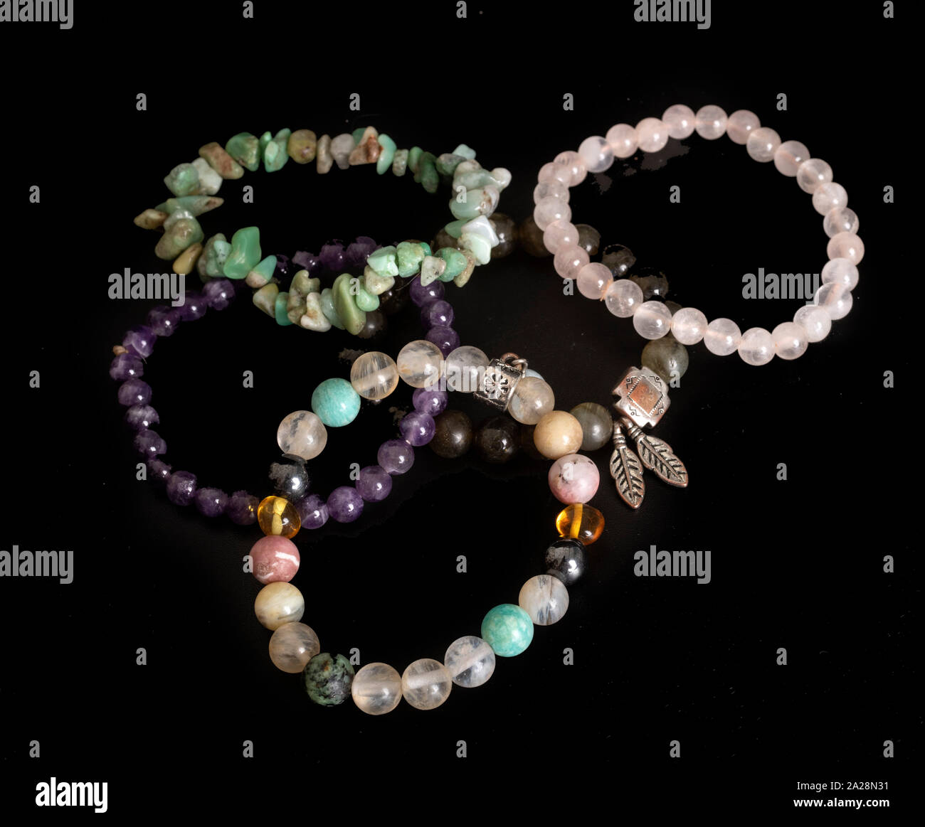 gem bracelets in front of black background Stock Photo - Alamy