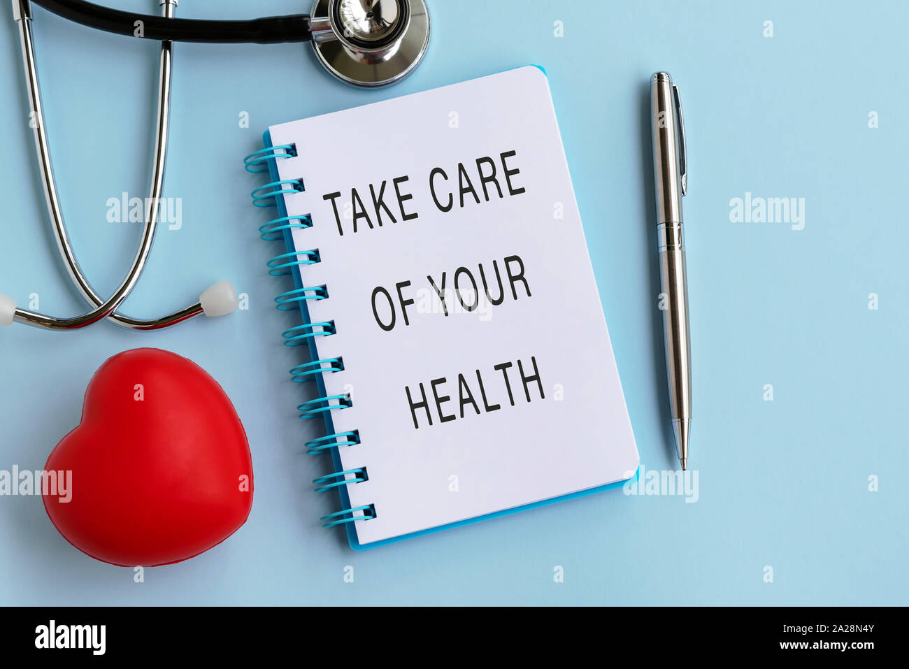 Take care of your health on note pad, flat lay stethoscope, heart shape ...