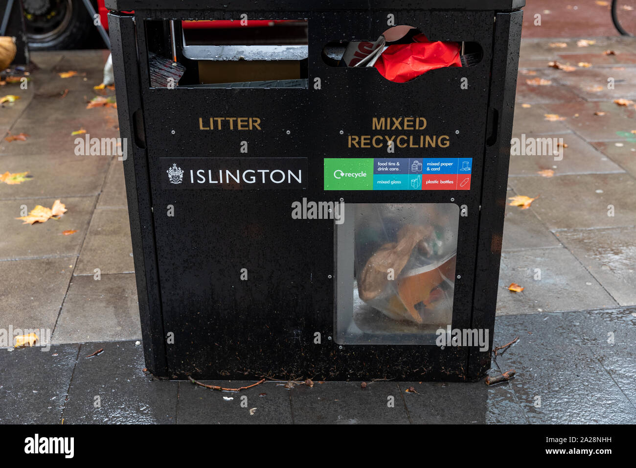 A public litter mixed recycling bin on a city street in Islington Stock ...