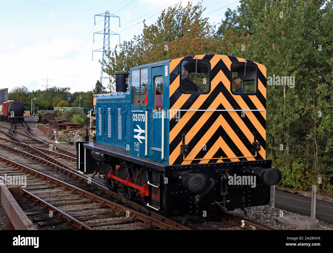 A preserved small shunting locomotive rests in the yard at the ...