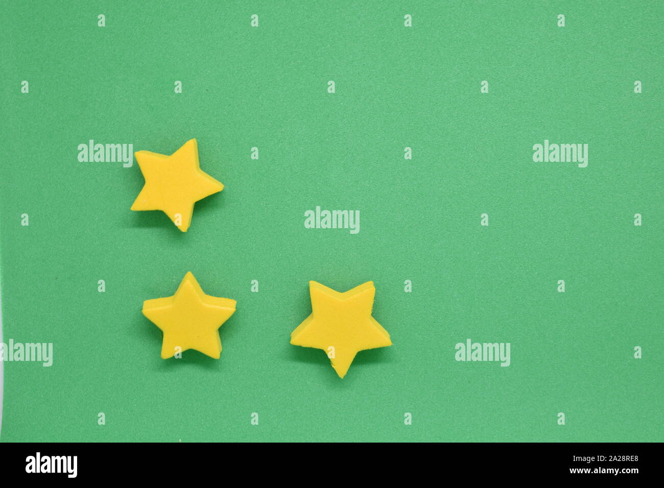 Smooth green single color abstract background with yellow stars on one ...