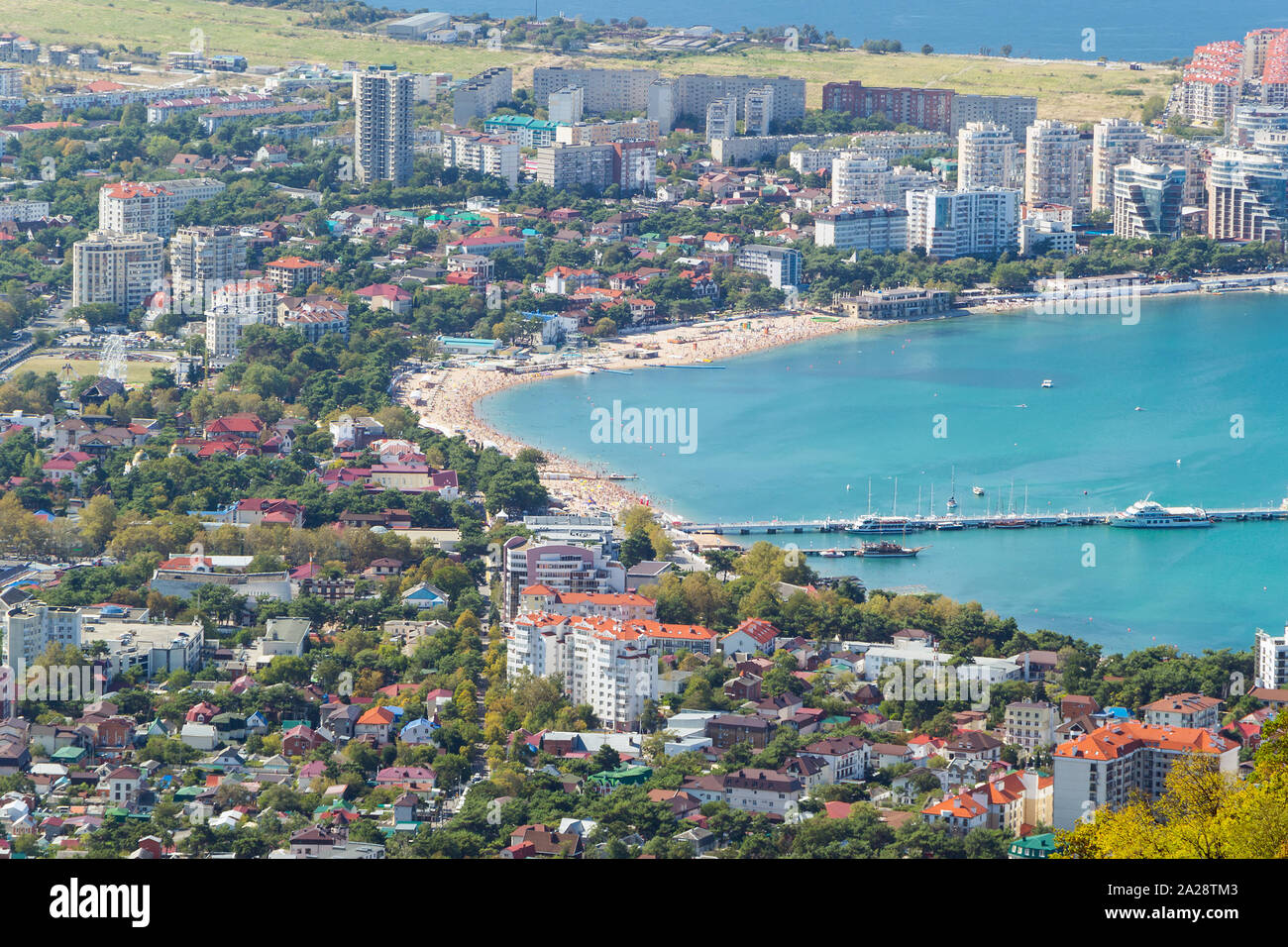 Resort town. Bird's-eye view. Sunny day in Gelendzhik. Turquoise water ...