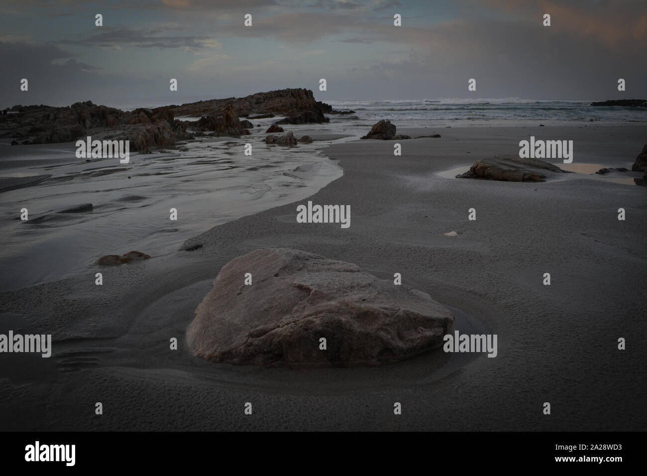 Morning ocean view with rocks on the beach Stock Photo - Alamy