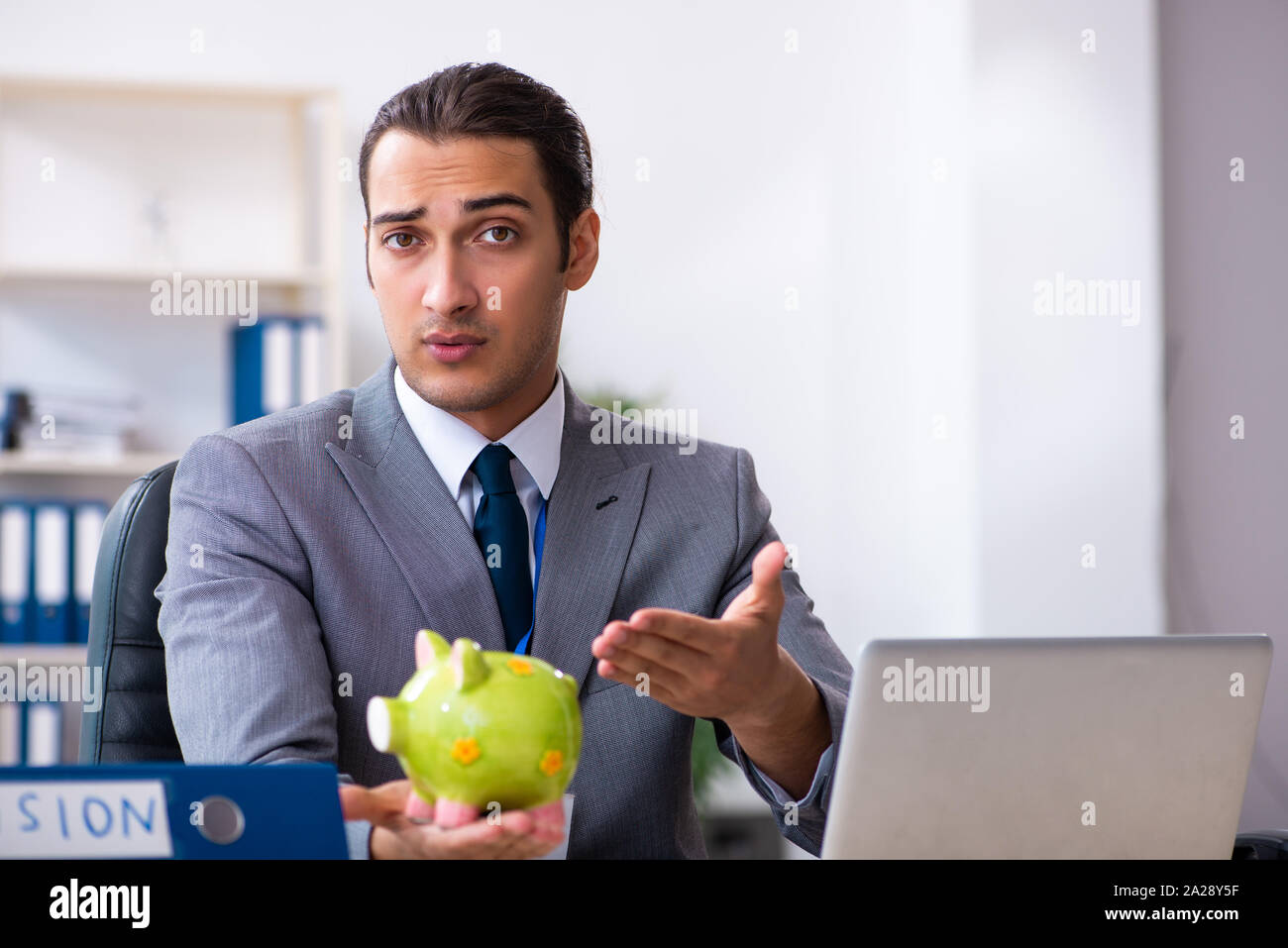 The young male accountant working in the office Stock Photo - Alamy
