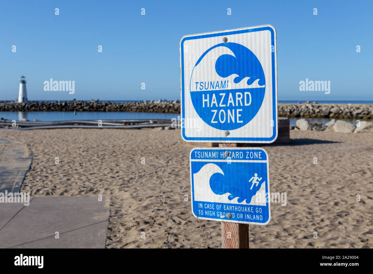 Tsunami Hazard Zone and Evacuation Signs with Lighthouse in distance ...