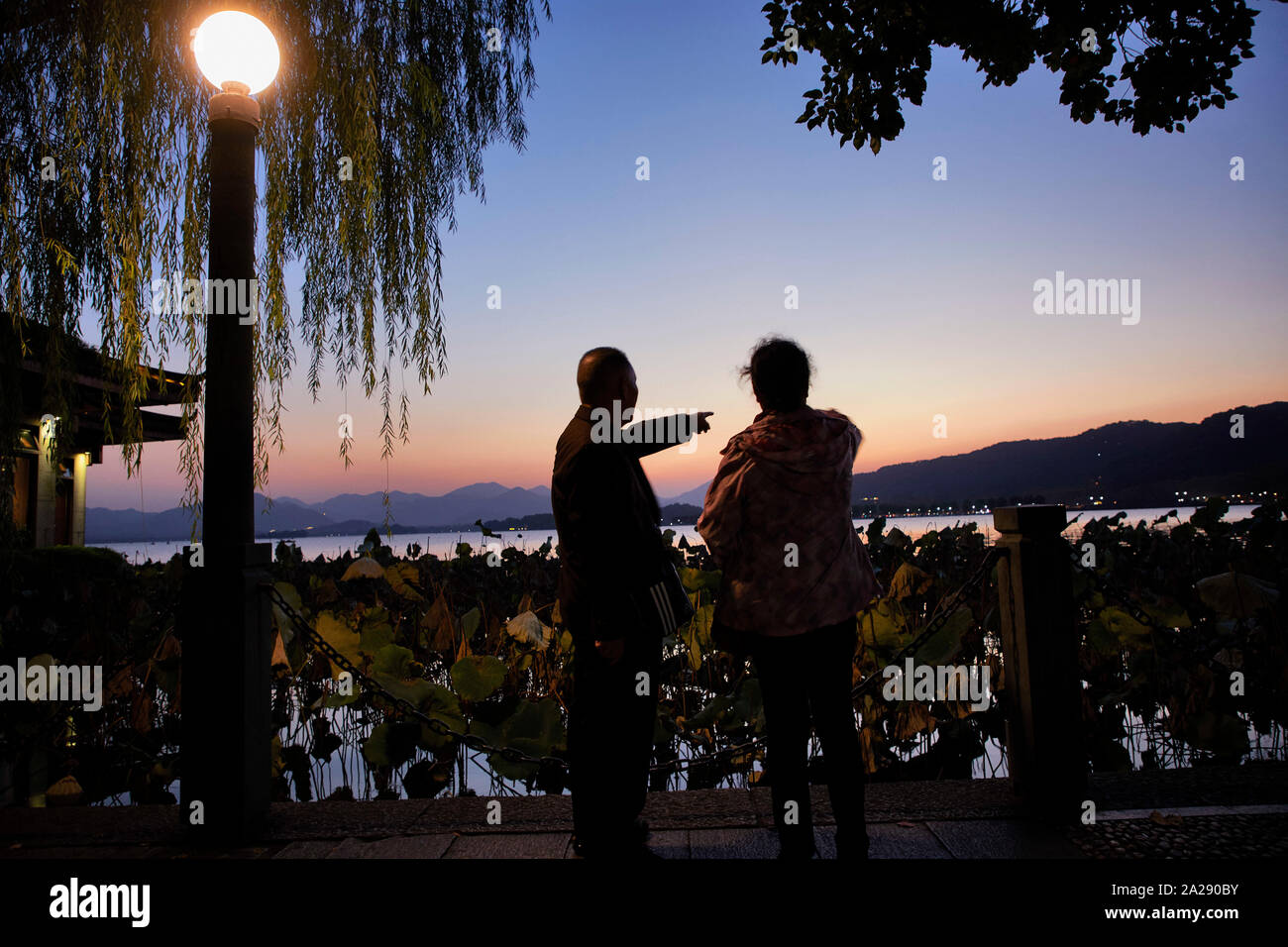 China Hangzhou West Lake People walking in the evening around the lake ...
