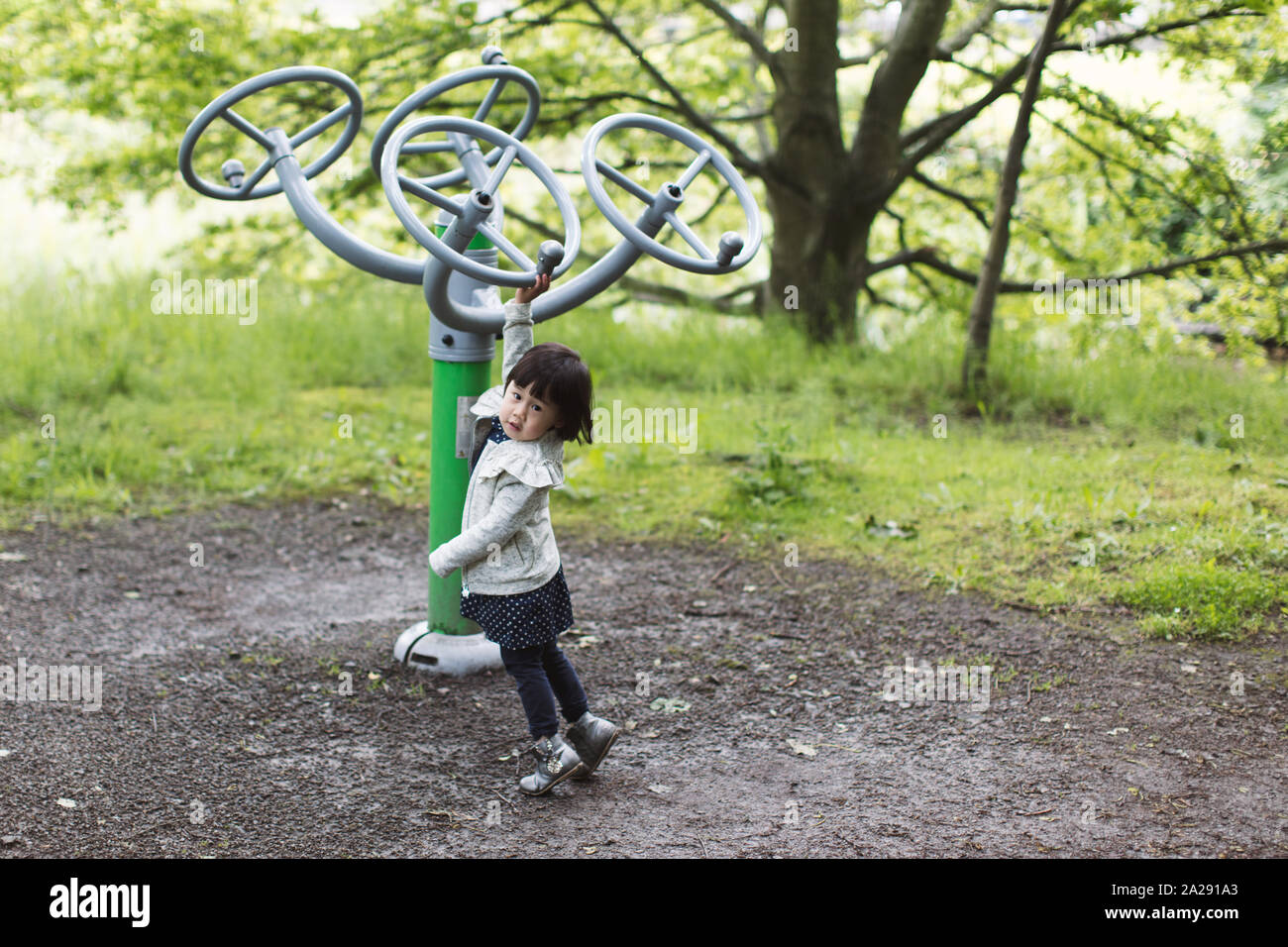 toddler girl play at Spring outdoor playground Stock Photo - Alamy