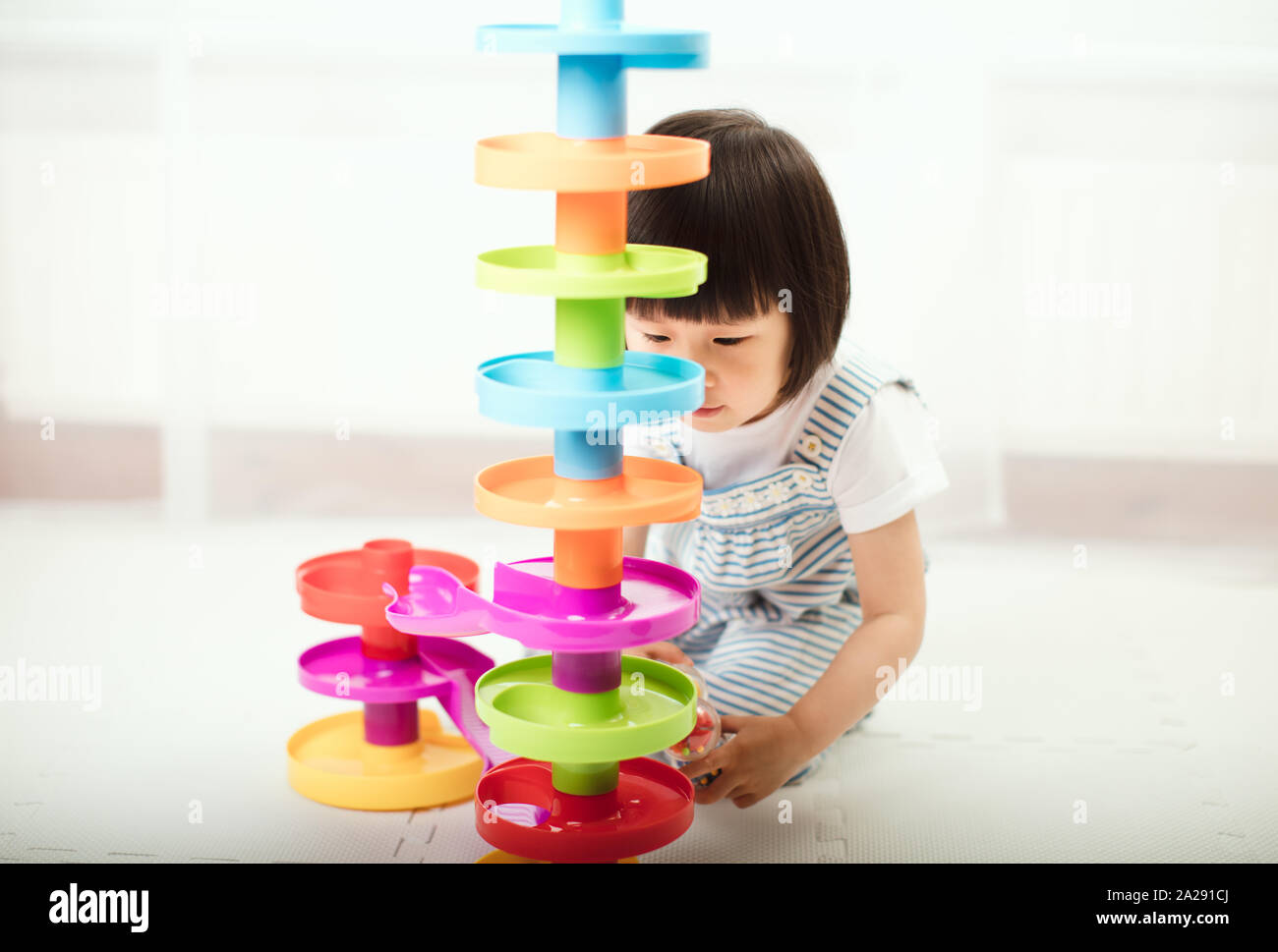 toddler girl play stack ball game at home Stock Photo - Alamy
