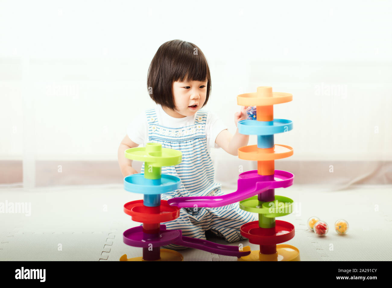 toddler girl play stack ball game at home Stock Photo - Alamy