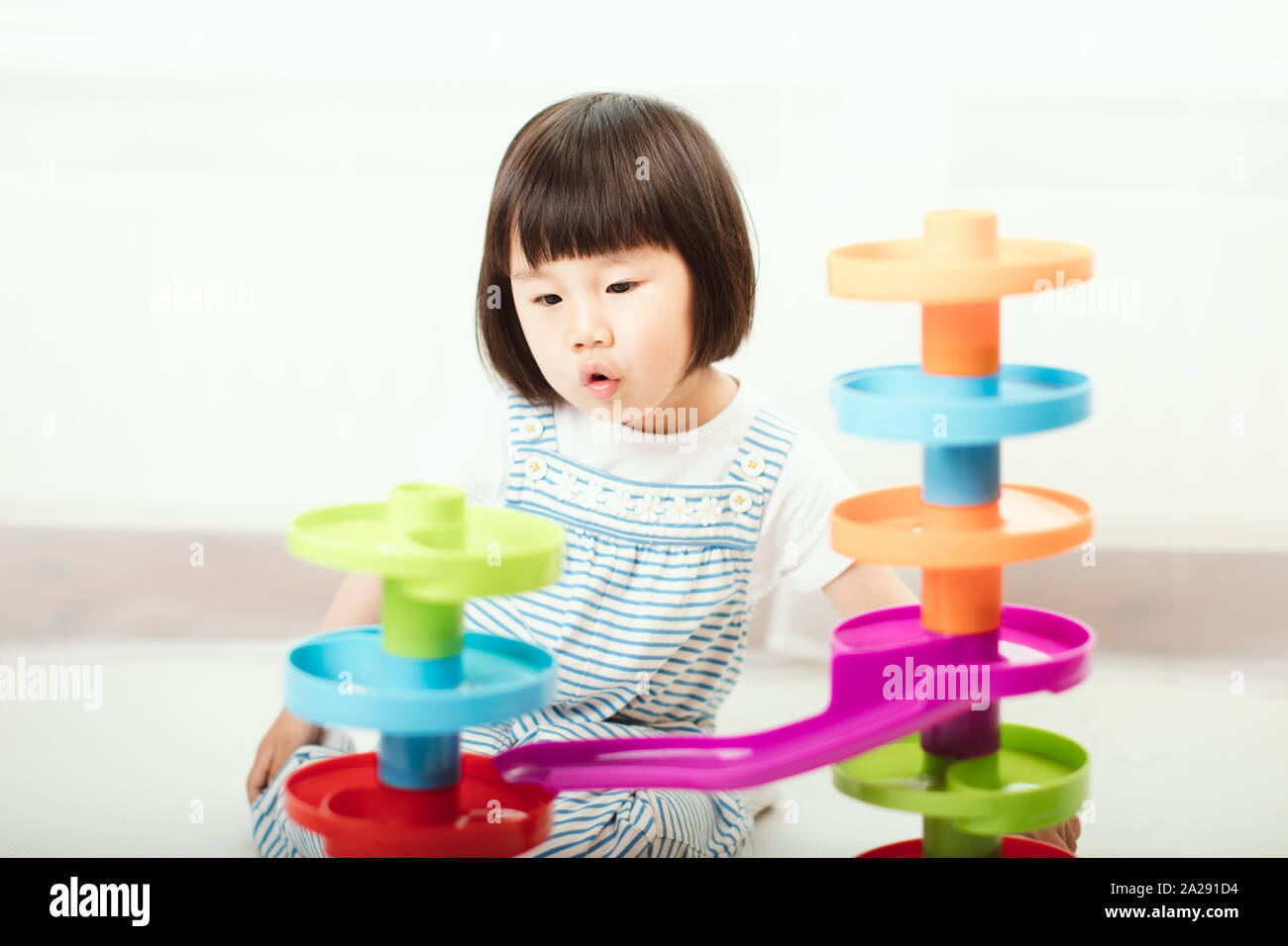 toddler girl play stack ball game at home Stock Photo - Alamy