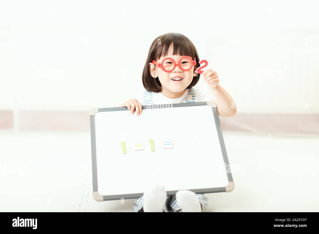 toddler girl using white board learning math at home Stock Photo - Alamy