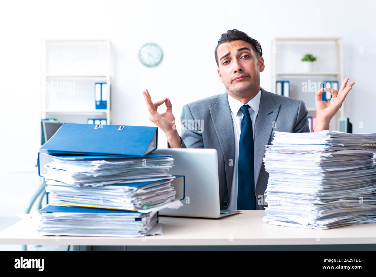 The businessman with heavy paperwork workload Stock Photo - Alamy