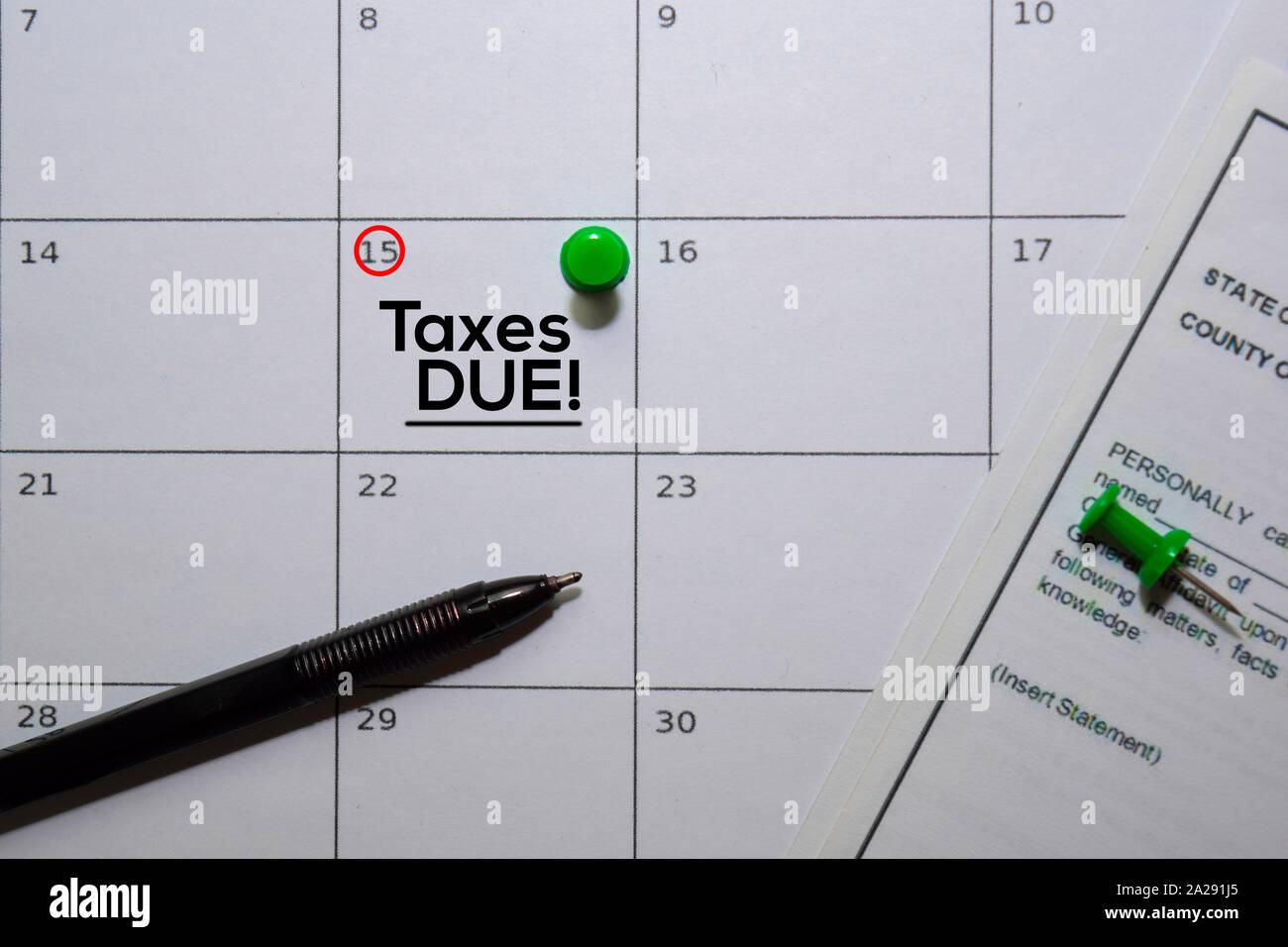 Taxes DUE! text on white calendar background. Reminder or schedule ...