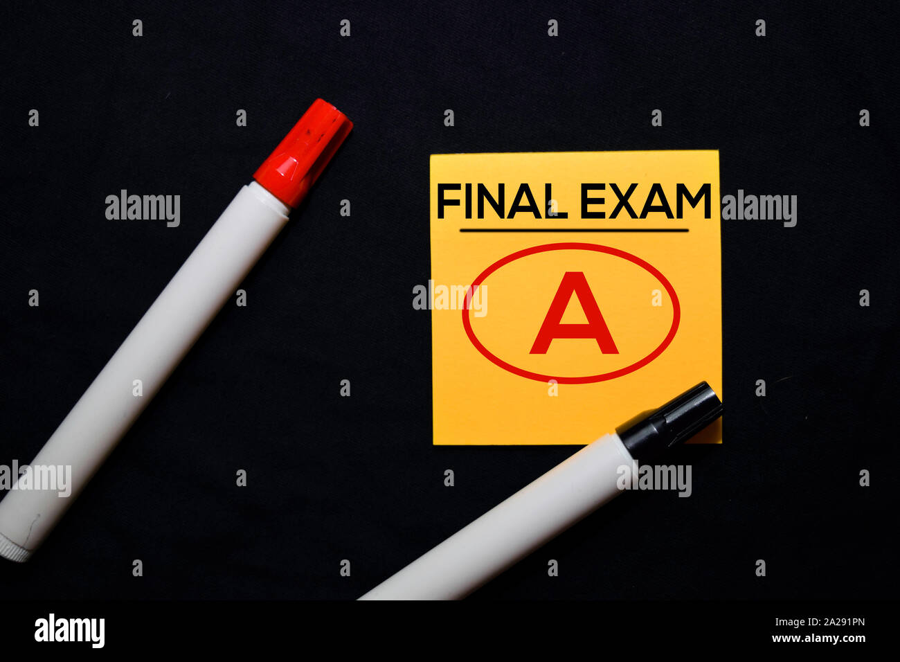Final Exam and A in red circle on sticky notes isolated on black ...
