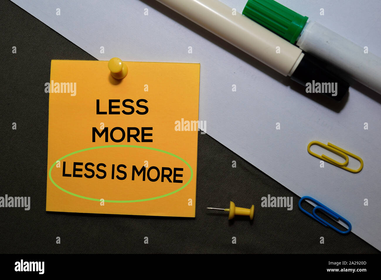 Less is More on sticky notes isolated on black white background Stock ...