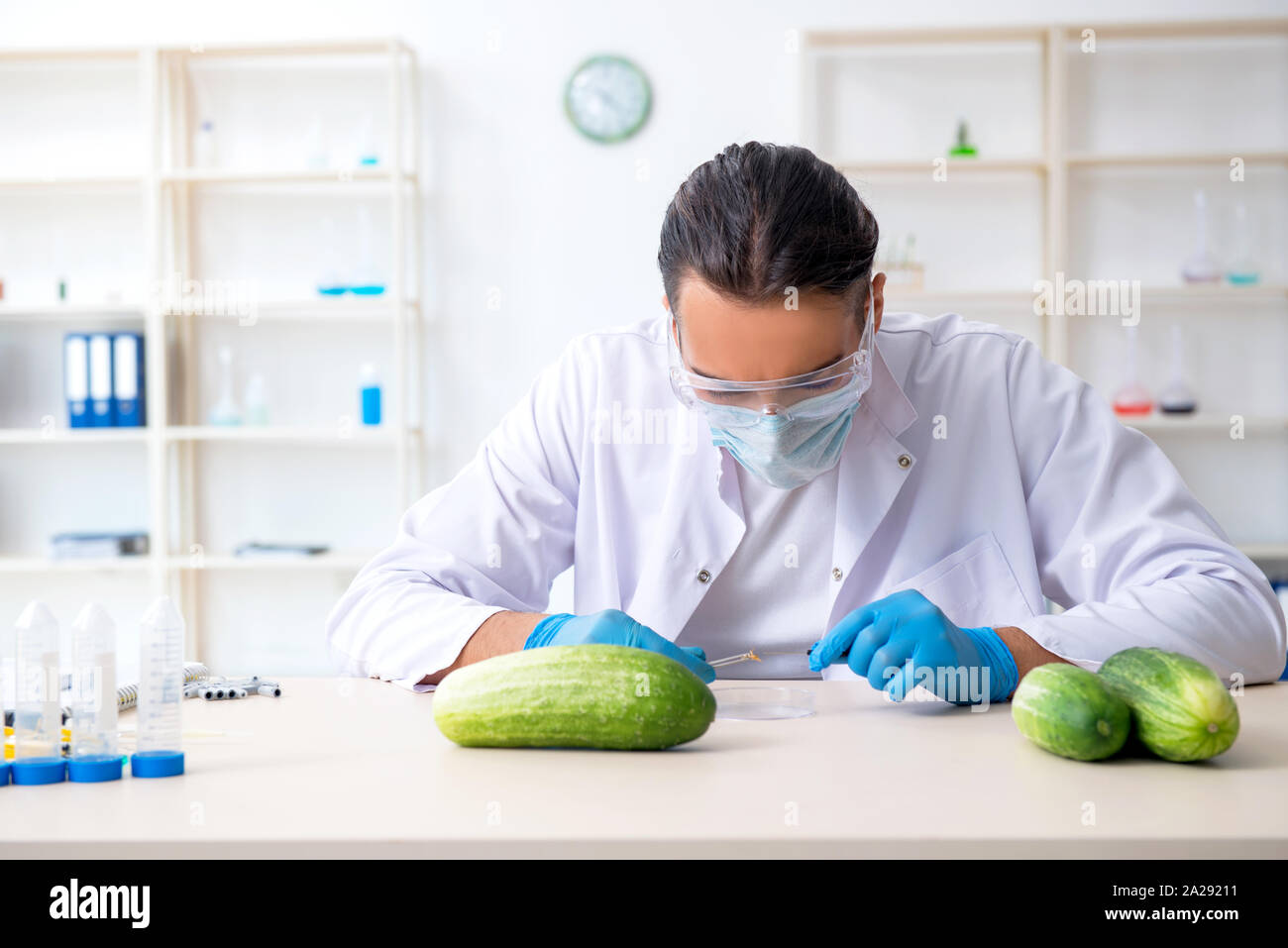 The male nutrition expert testing vegetables in lab Stock Photo - Alamy