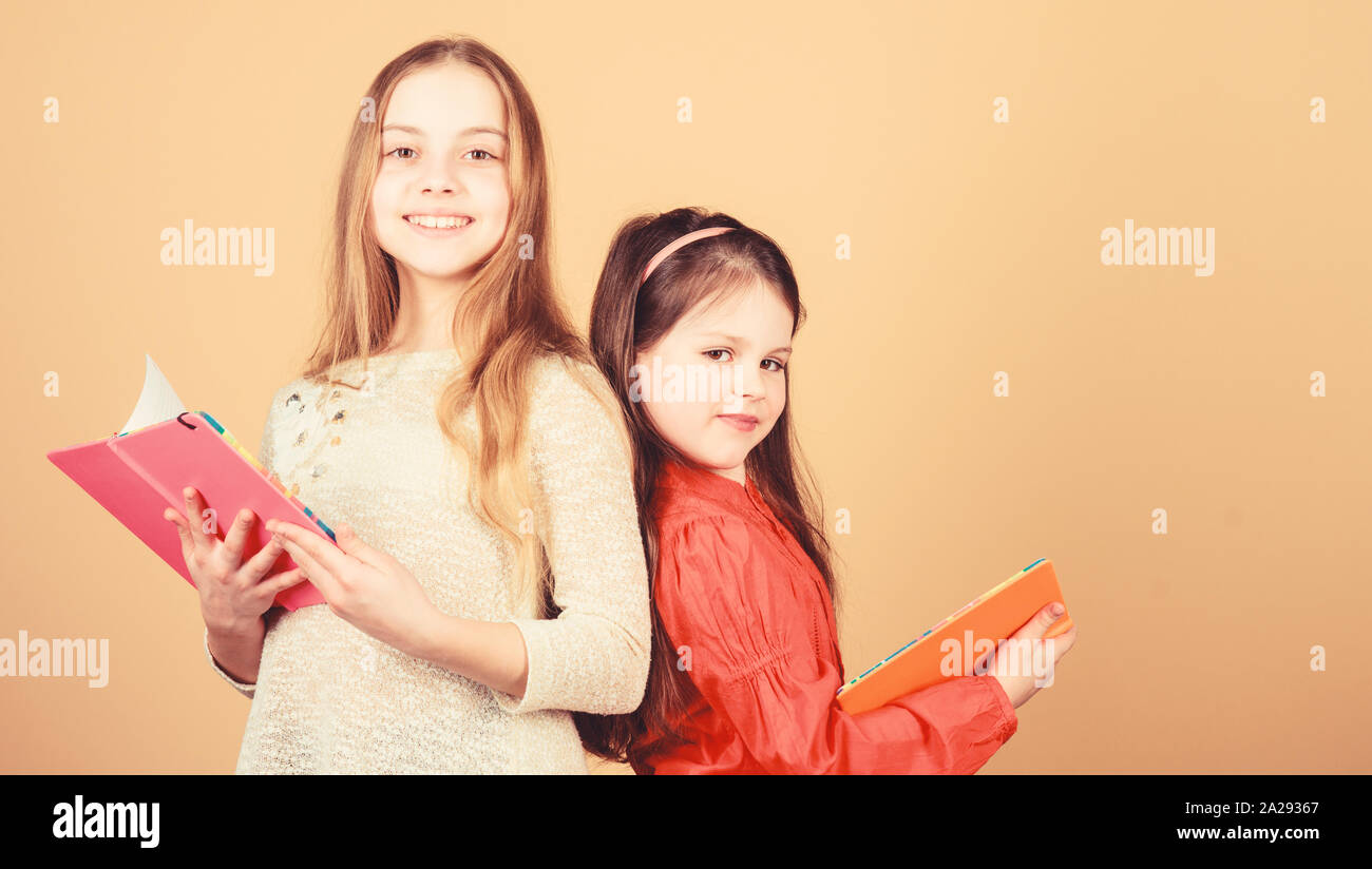 happy little children ready for school lesson. small girls with note ...