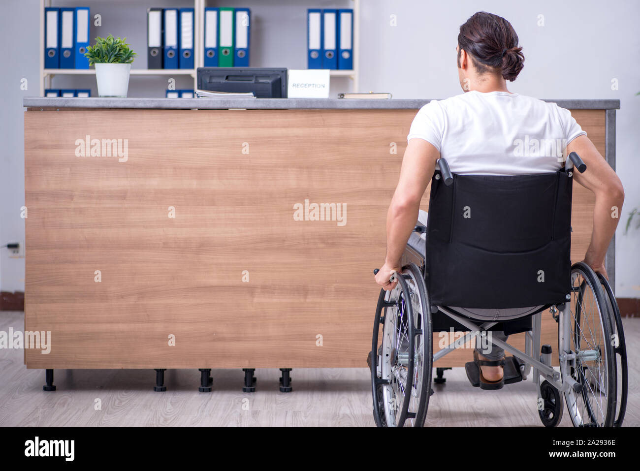 Clinic reception counter and young patient Stock Photo - Alamy